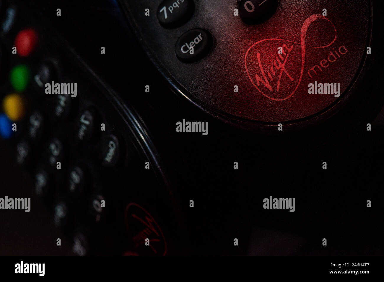 Virgin media television control close up, isolated on a mirrored ...