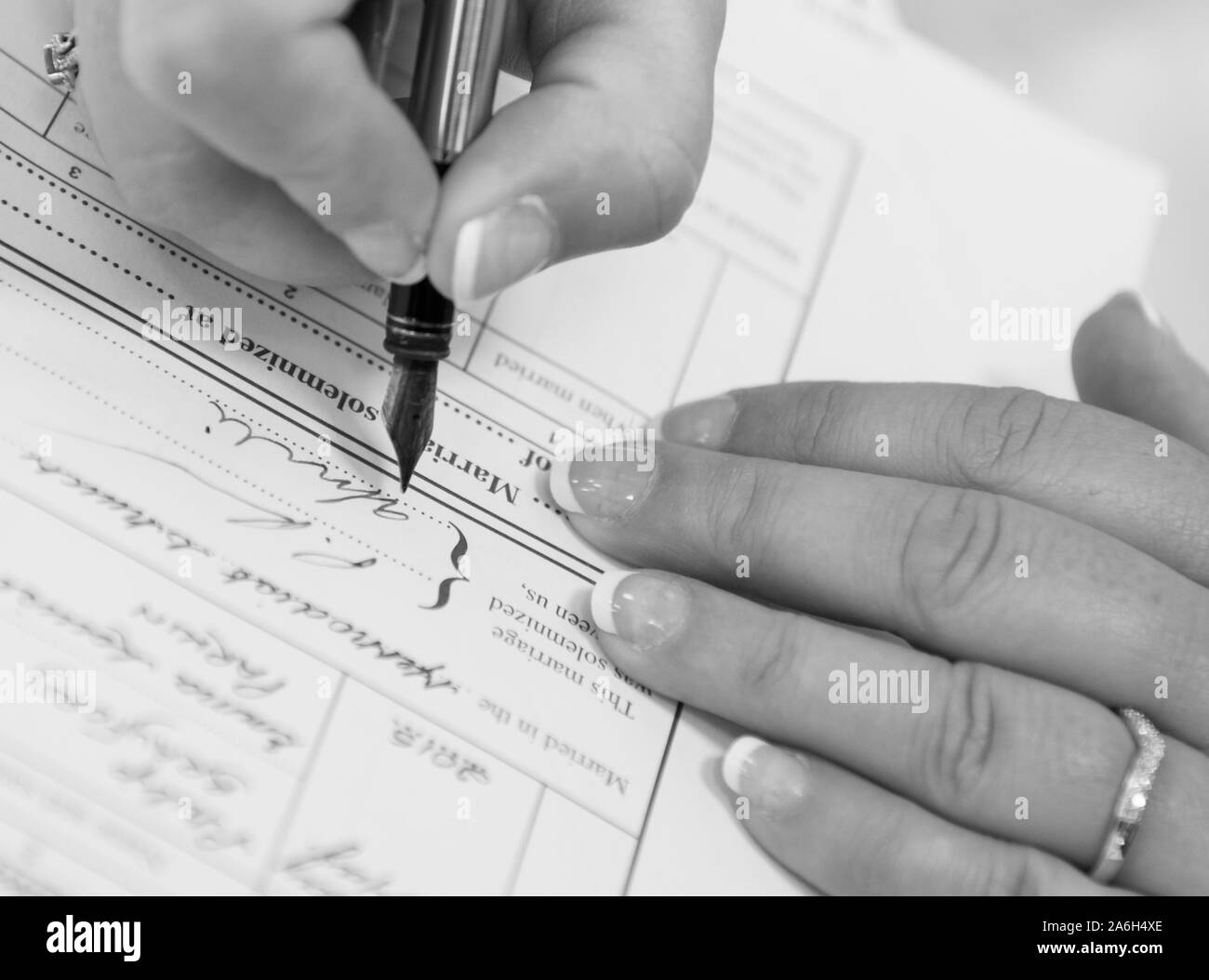 Bride and Groom signing the register after the ceremony Stock Photo - Alamy