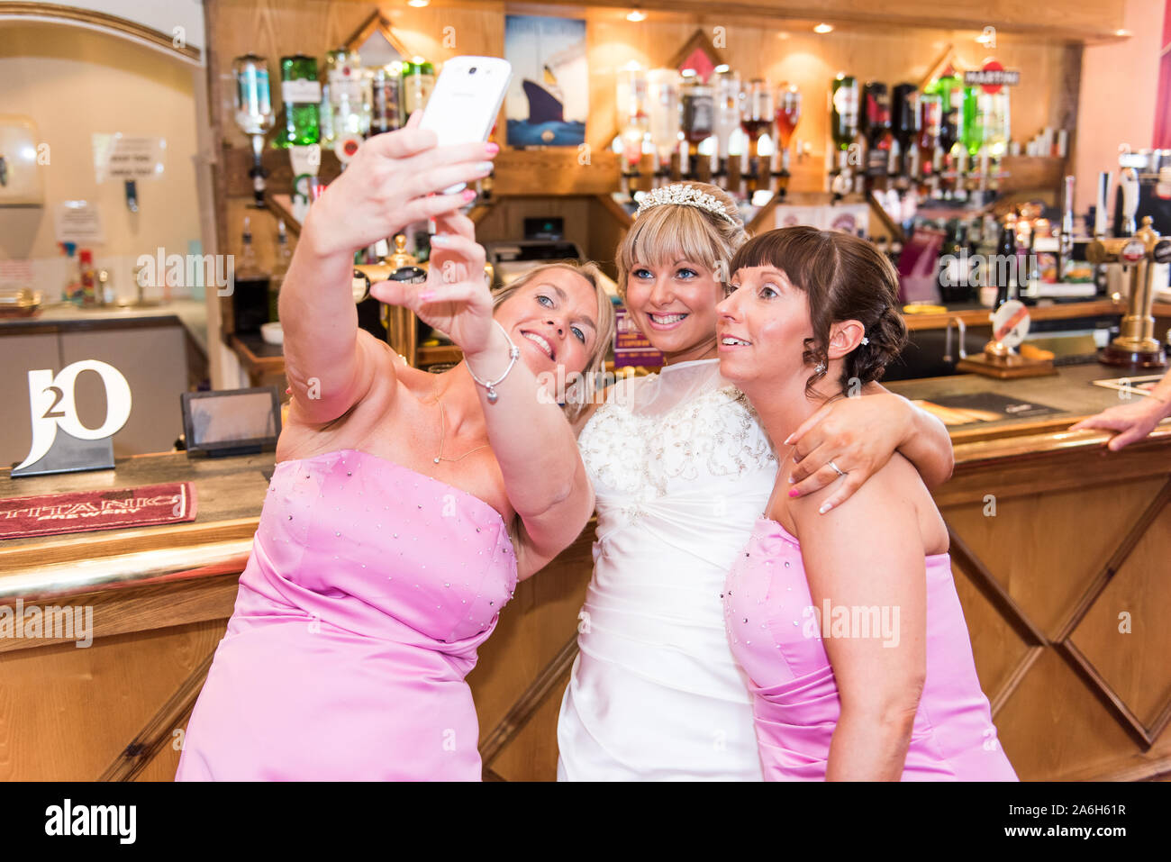 Bride and bridesmaids pose for a selfie after the wedding ceremony ...