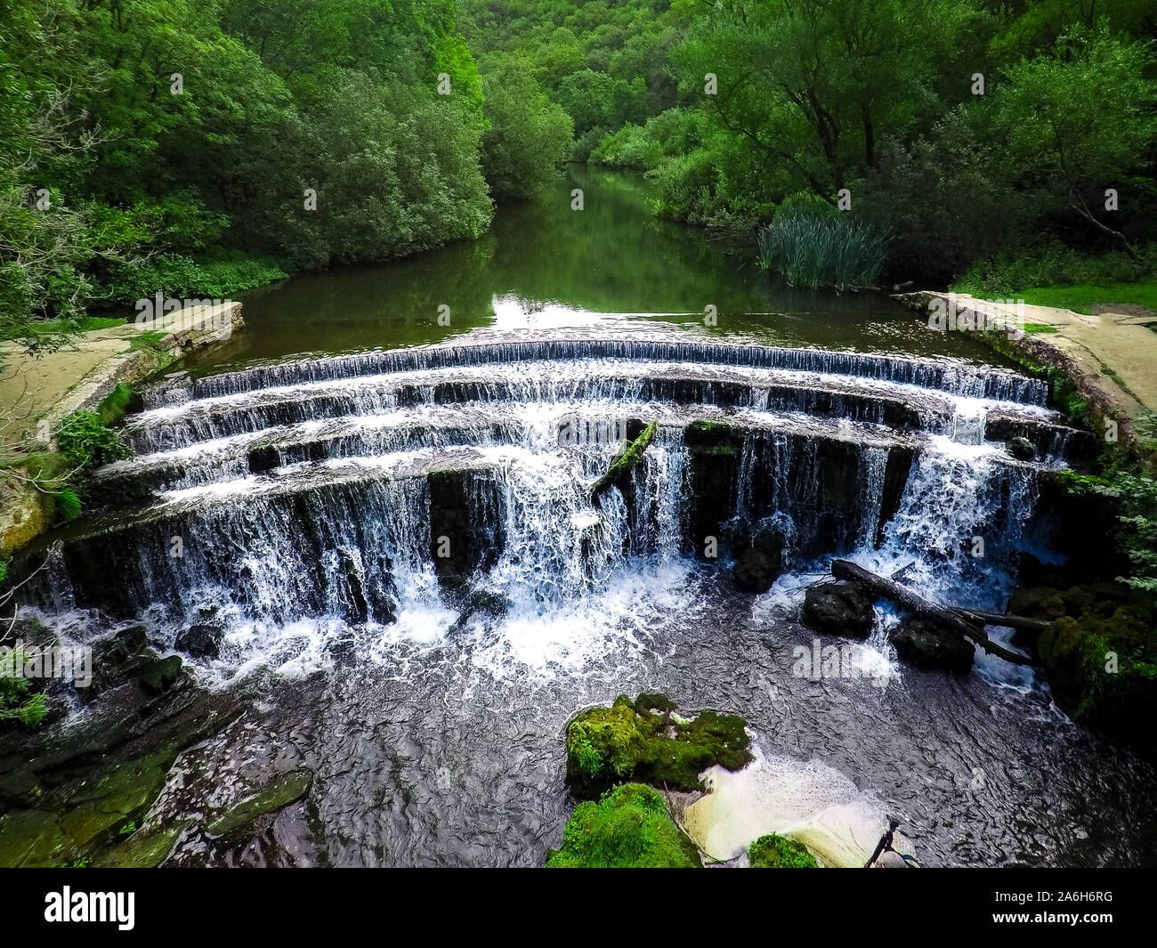 Aerial view of a little waterfall in Bakewell, the Derbyshire Peak ...