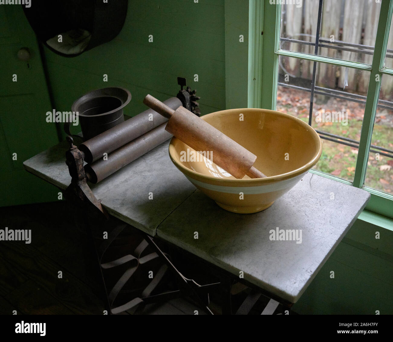 Vintage mixing bowl and rolling pin on an antique pastry table on ...