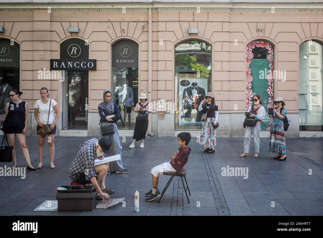 BELGRADE, SERBIA - JULY 6, 2019: Street cartoonist drawing the ...