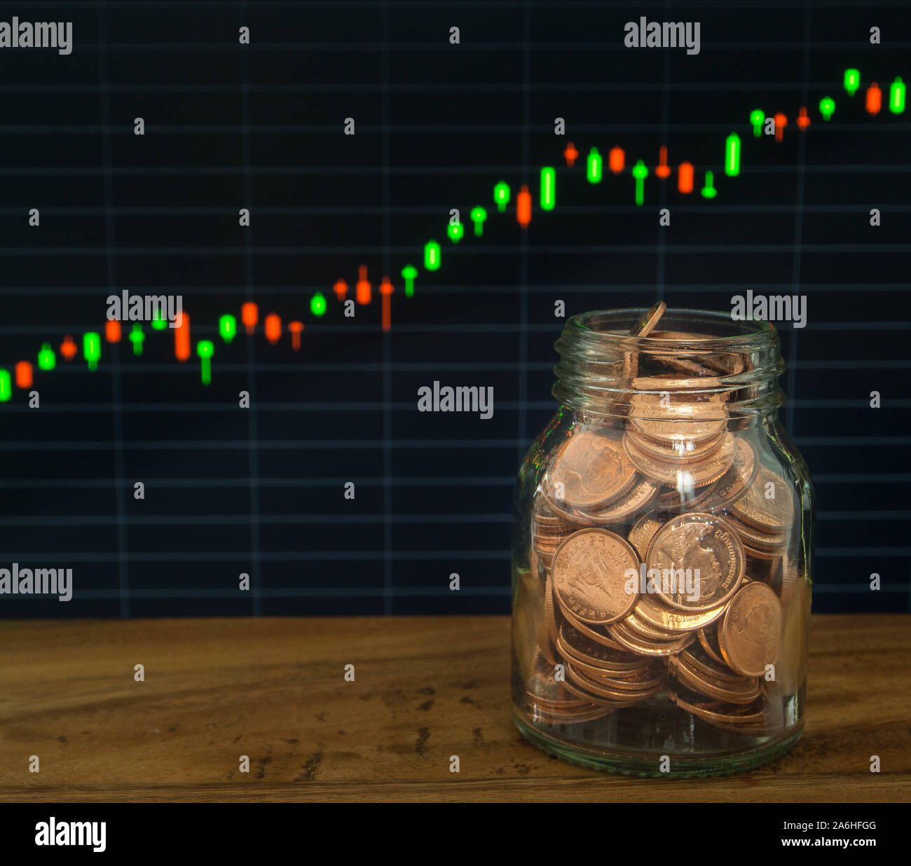 golden coins jar on the financial stock charts as background Stock ...