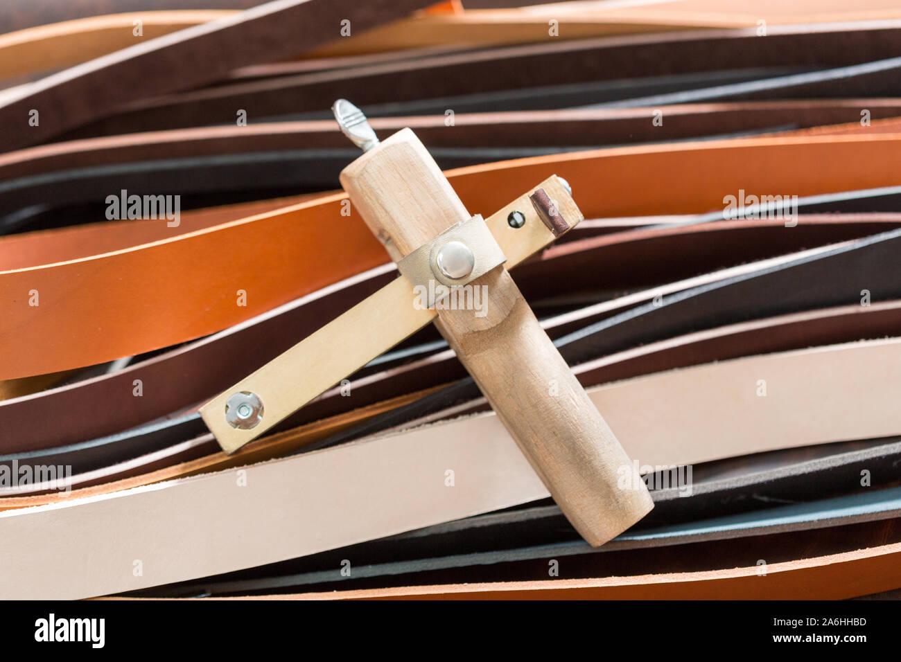 The strap cutter close up on leather pieces Stock Photo - Alamy