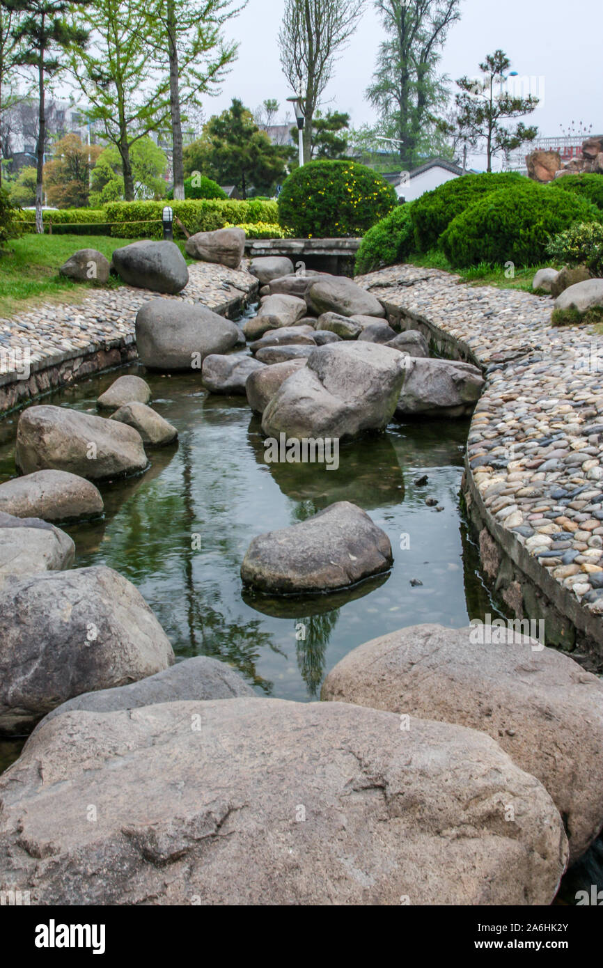 Pond with rocks and pebble stones in garden park Stock Photo - Alamy