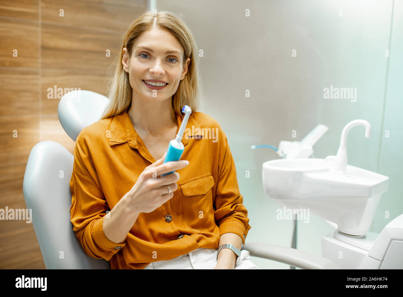Portrait of a beautiful and cheerful woman as a patient with electric ...