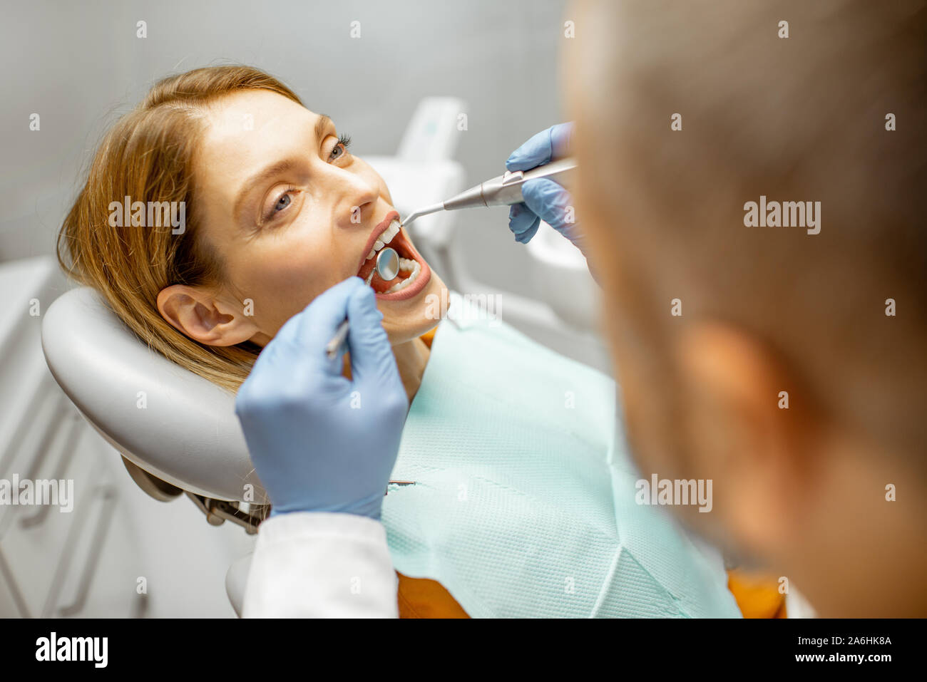 Beautiful woman as a patient during a teeth inspection with a senior ...
