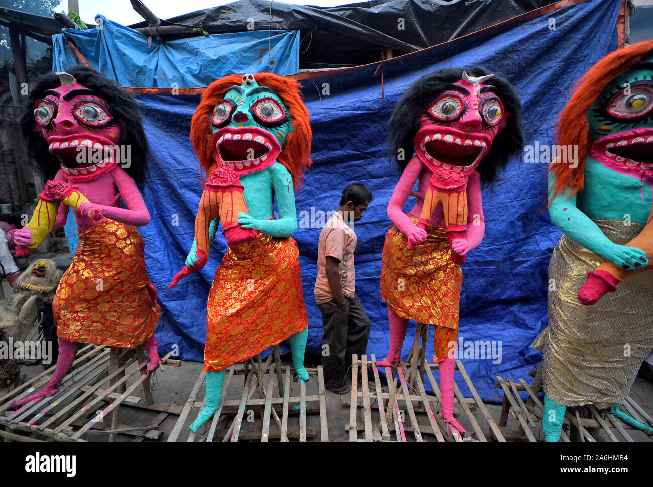 Kolkata, India. 26th Oct, 2019. A man walks past big size demon clay ...