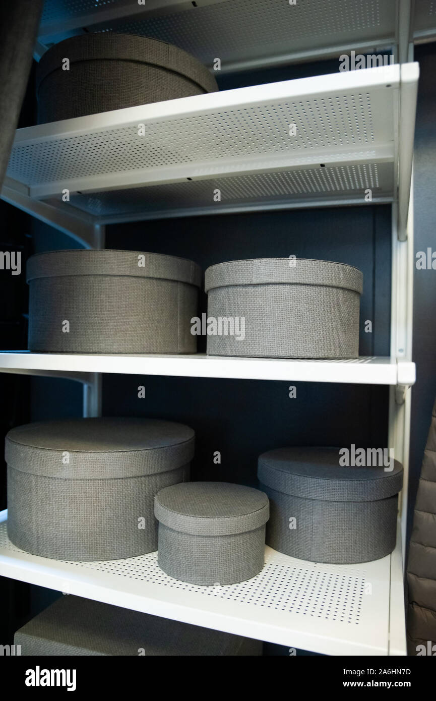 Round boxes for storage of gray color on the shelf, the theme of ...