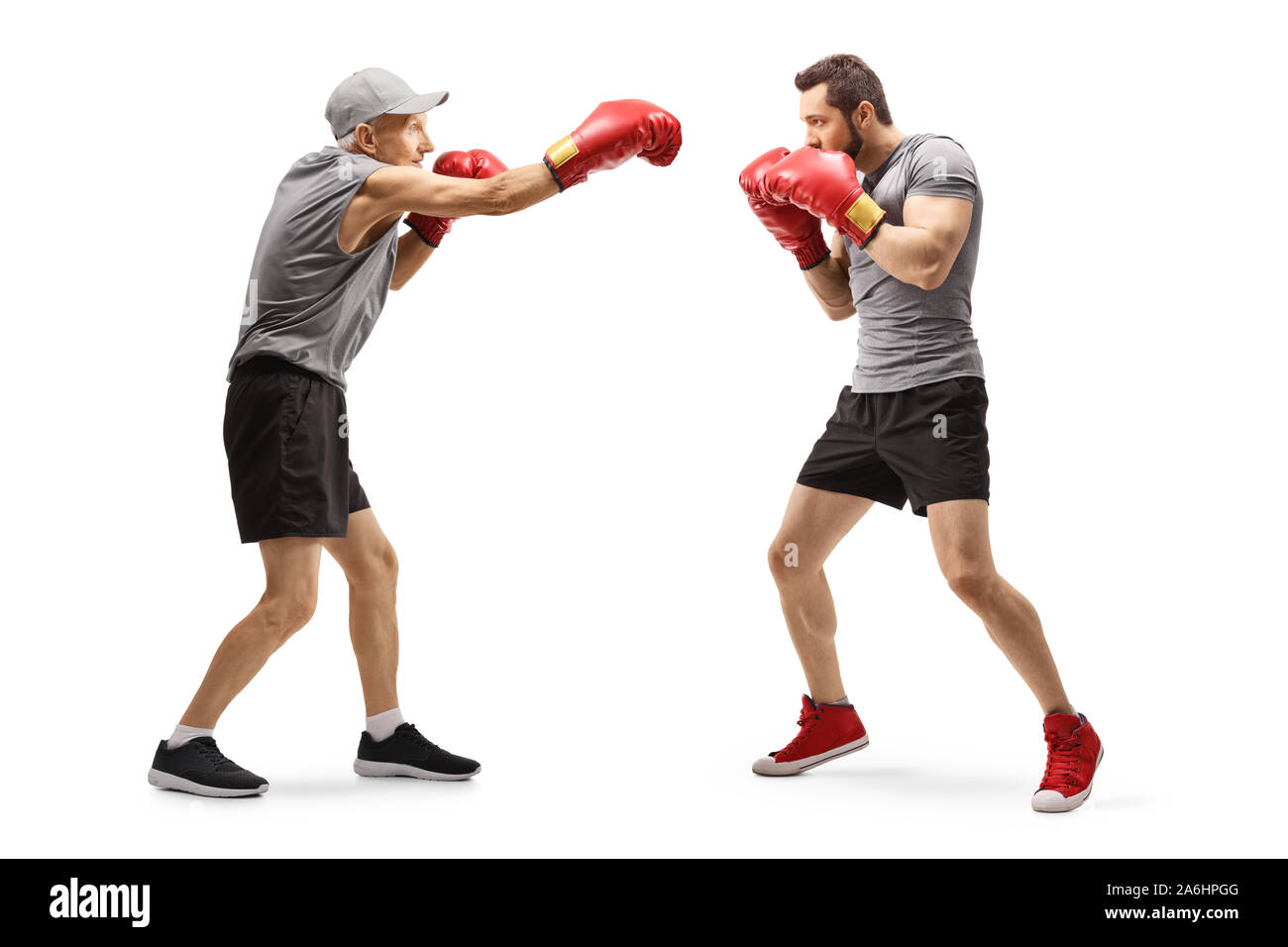 Full length shot of a senior man and a young man boxing isolated on ...