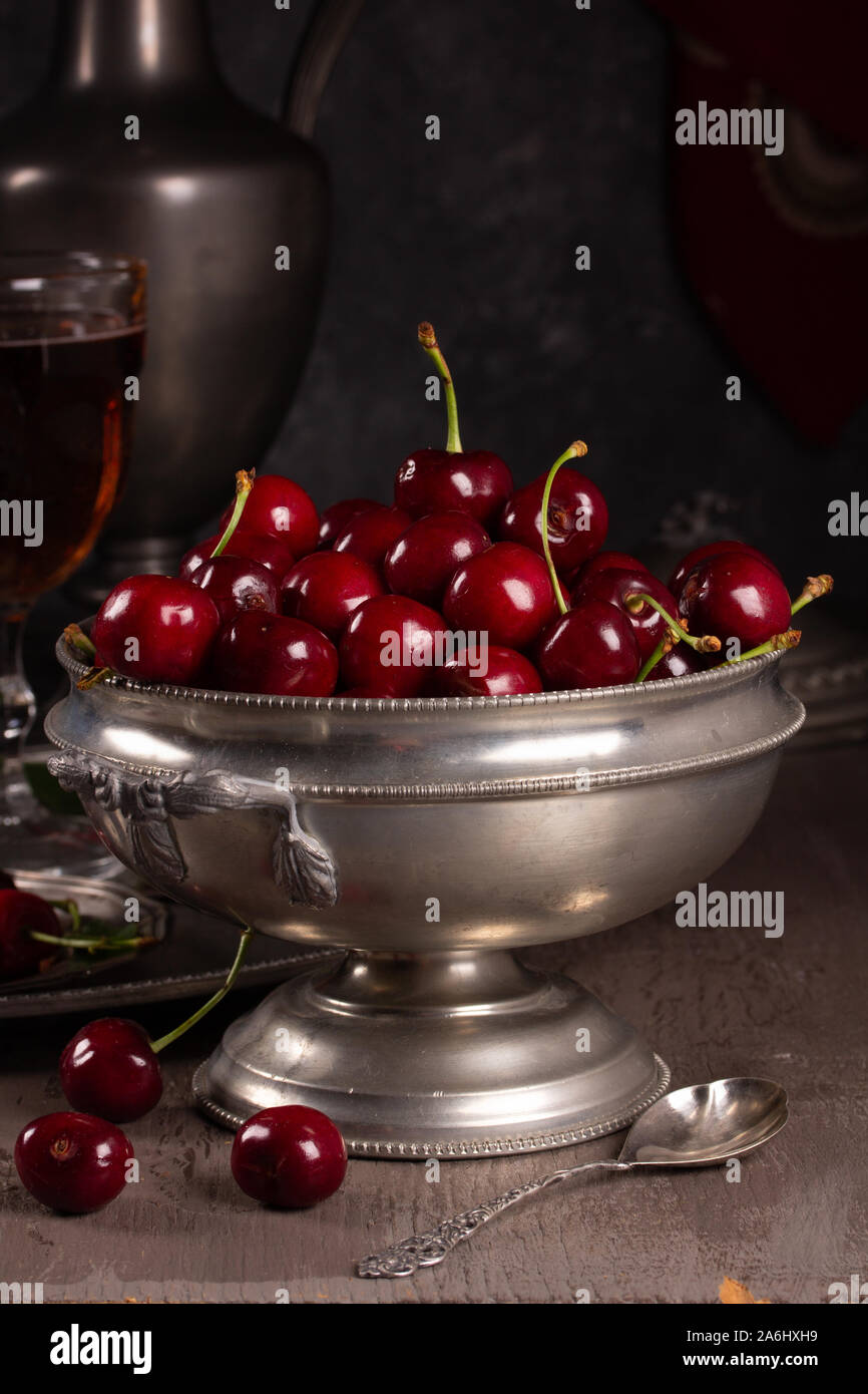 Vintage still life with cherry and pewter Stock Photo - Alamy