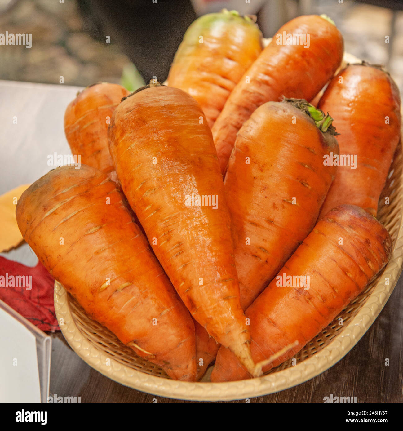 Farm vegetables carrots of different colors are in the window of the ...