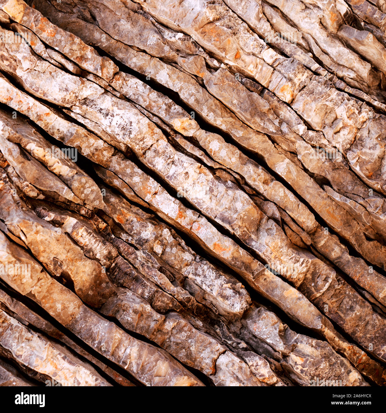 Textured layers and cracks in the rock on cliff face. Nature abstract ...