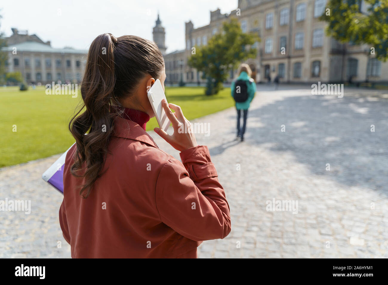 Back view of a beautiful young woman making a smartphone call Stock ...
