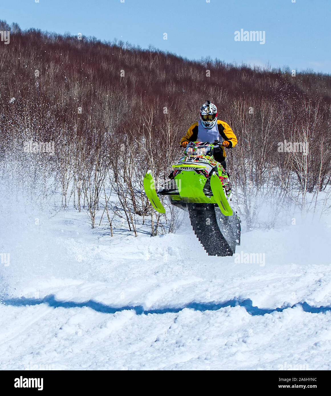 The Snowmobile in high jump above track Stock Photo - Alamy