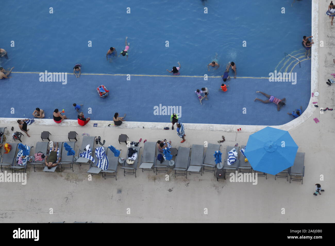 Busy Poolside wth chairs seen from top. Representing summer vacation ...