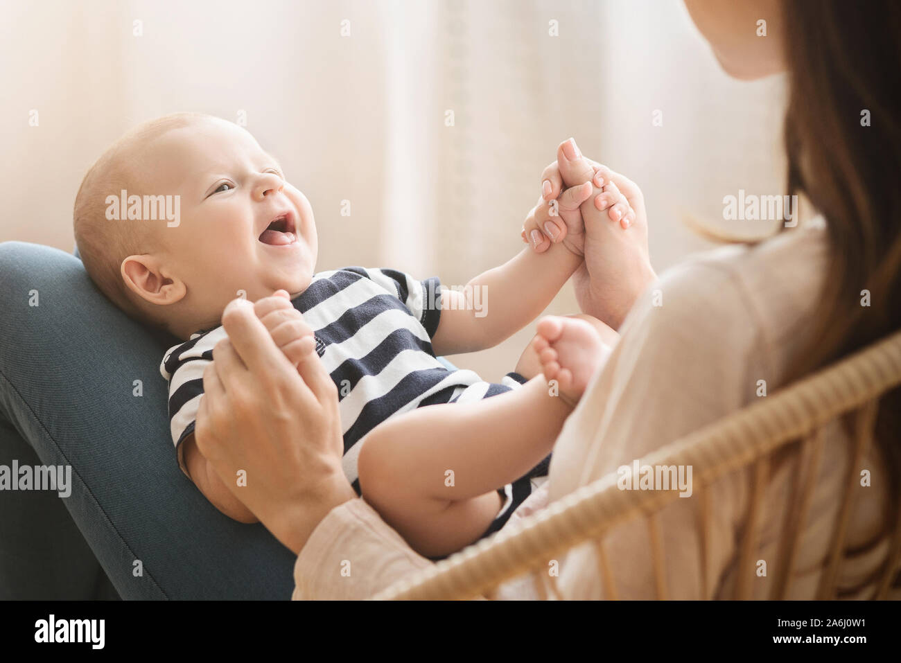 Portrait of sweet newborn child lying on mom's lap Stock Photo - Alamy