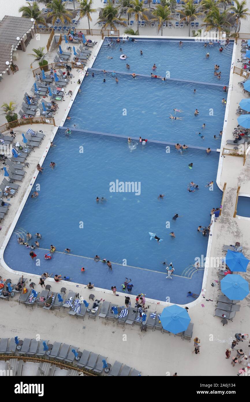 Busy Poolside wth chairs seen from top. Representing summer vacation ...