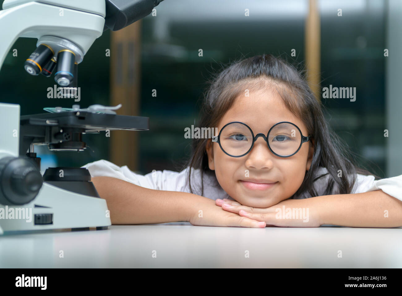 Happy Little child smile and learning in school laboratory using ...