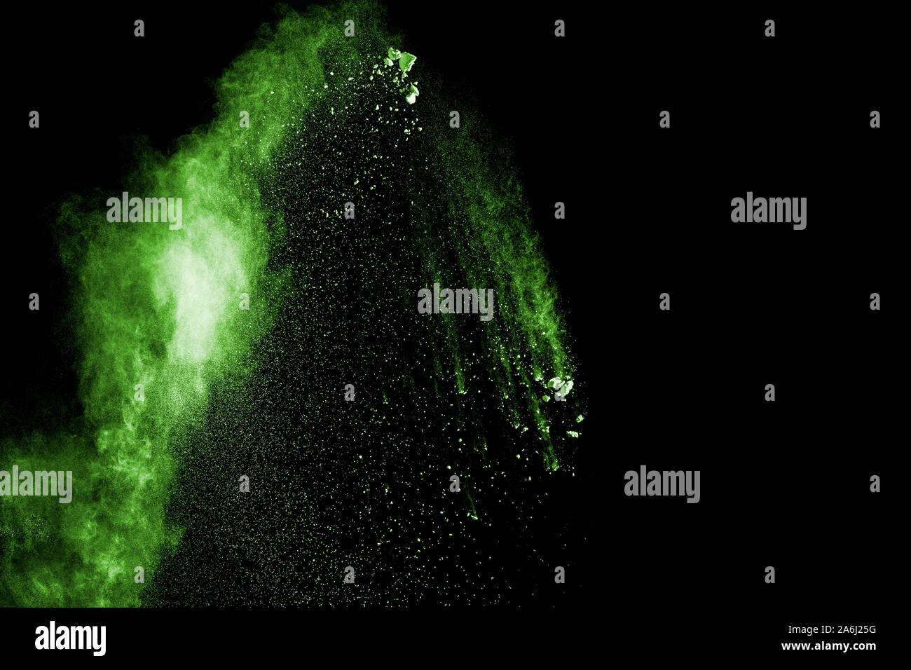 green powder explosion cloud on black background.Freeze motion of green ...