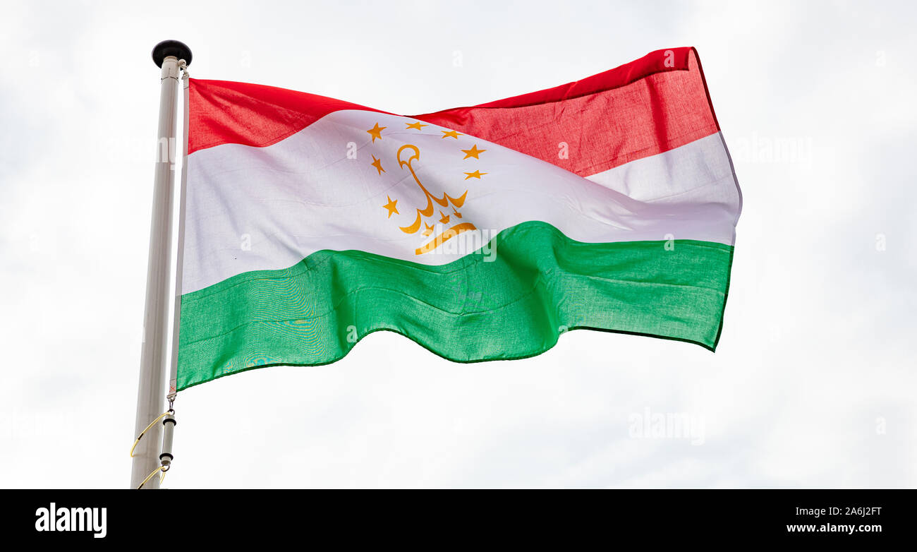 Tajikistan flag. Tajikistan national sign and symbol waving on a ...