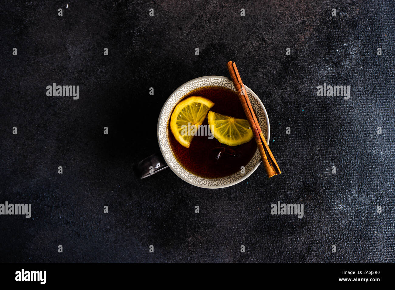 Mulled tea with lemon and spices on stone table with copy space Stock ...