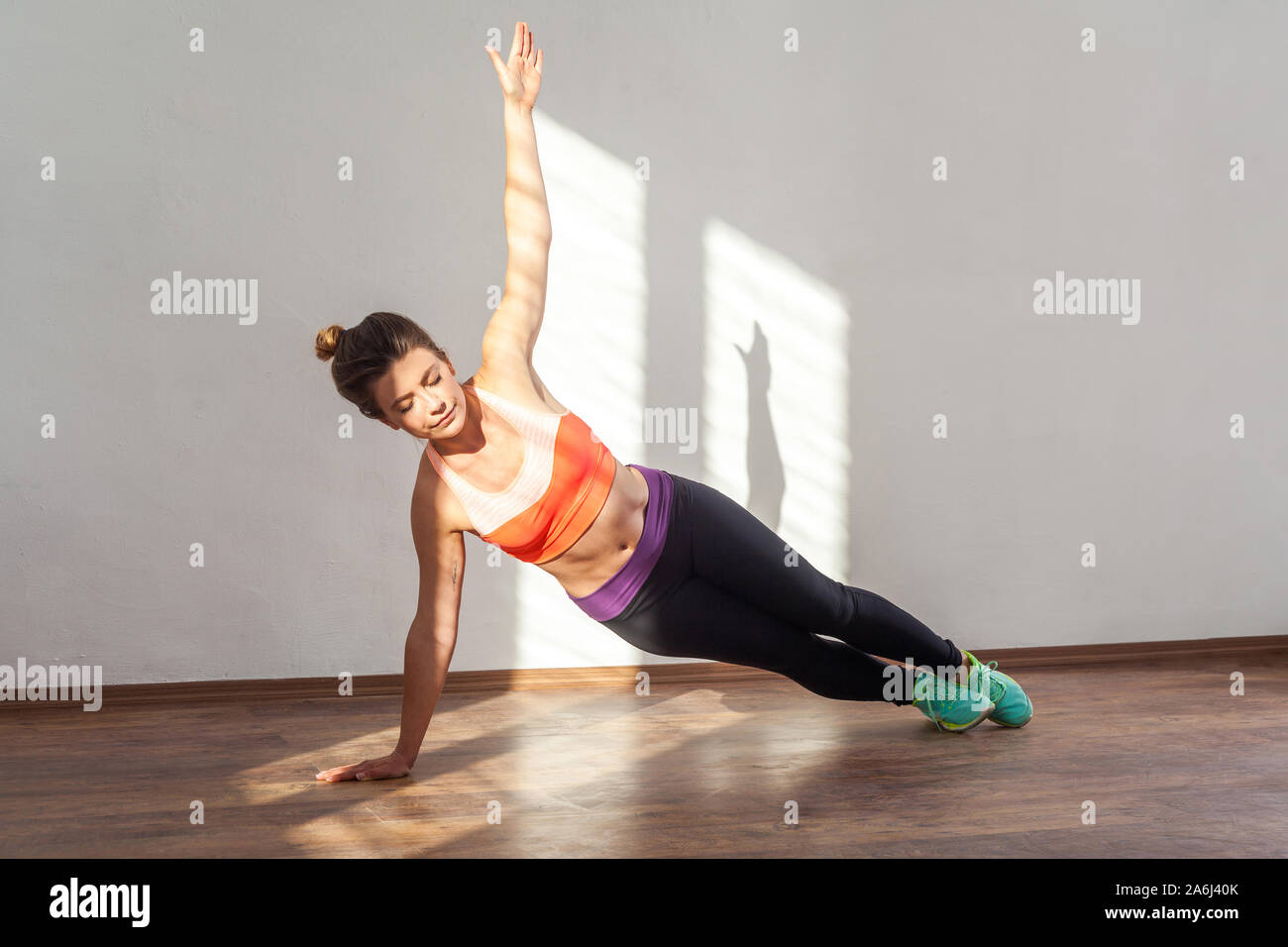 Side Plank Pose Yoga Class Fit Woman With Bun Hairstyle And In Tight