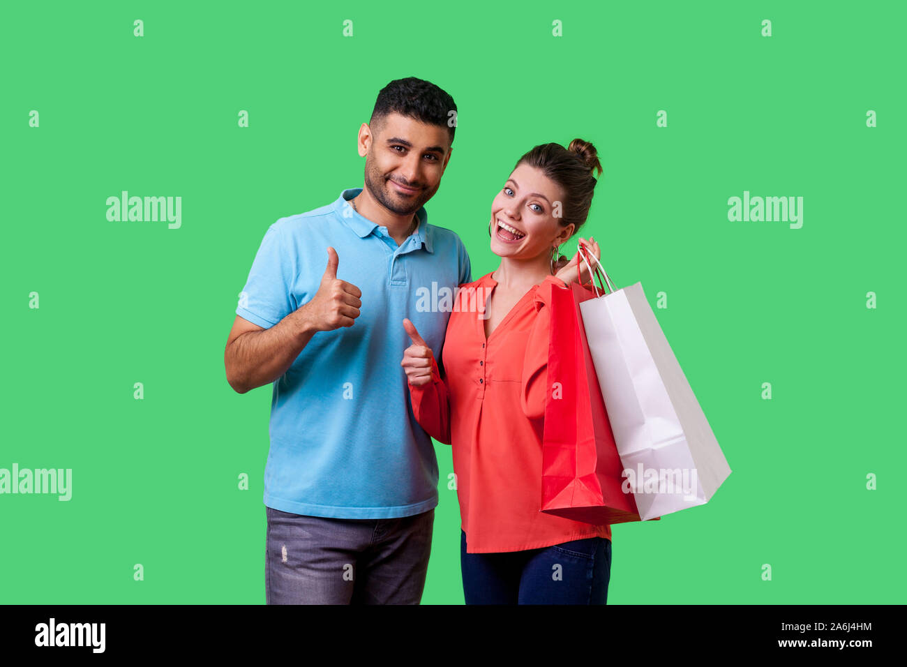 I like shopping. Portrait of satisfied young couple in casual wear ...