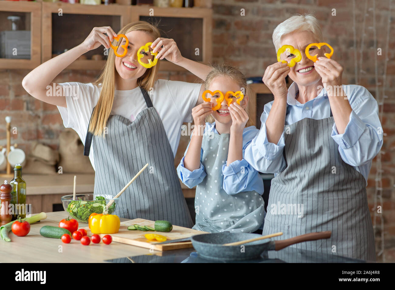 Cheerful family spending good time together while cooking Stock Photo ...