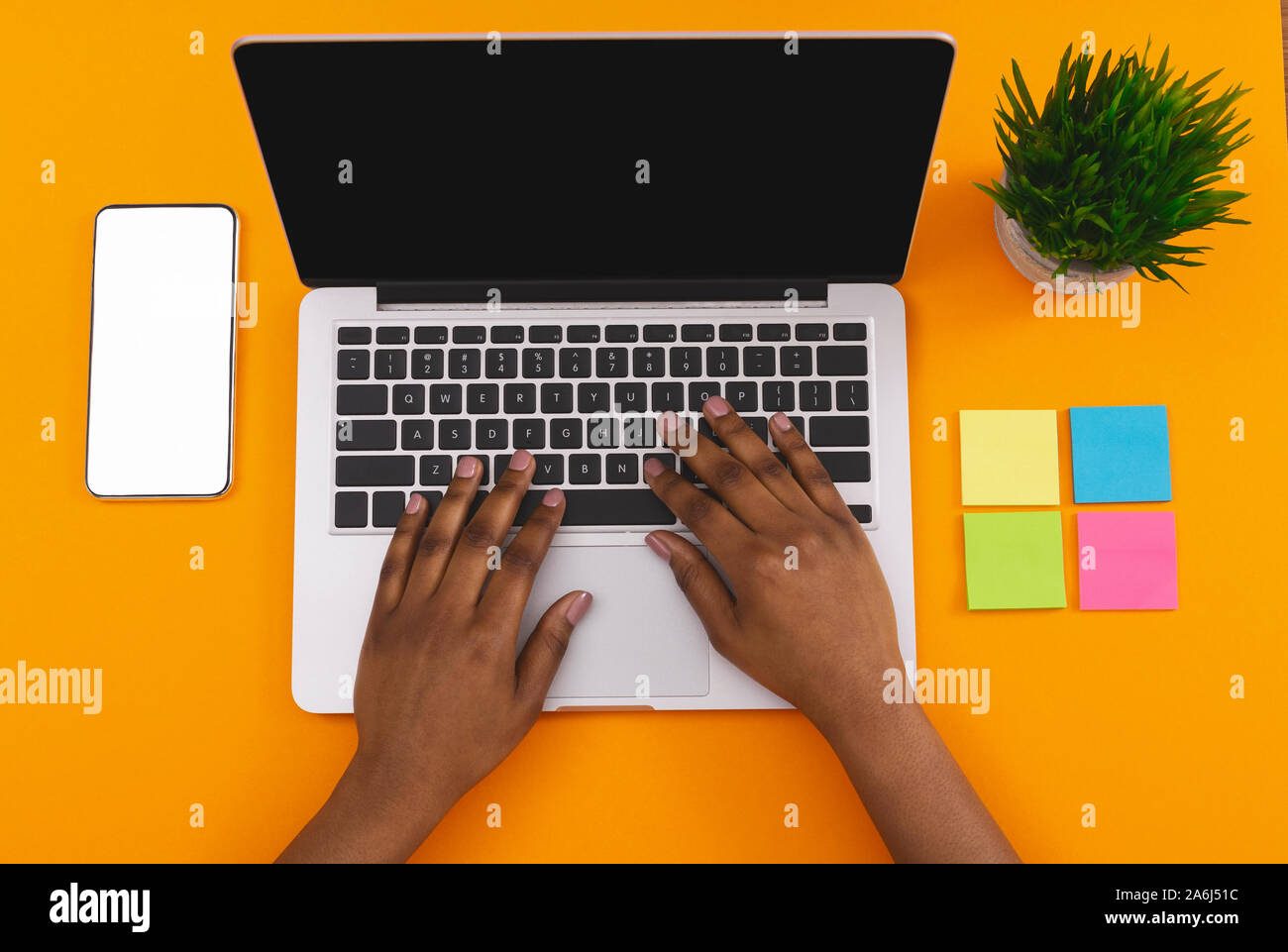 Black female hands typing on laptop over orange background Stock Photo ... Black female hands typing on laptop over orange background Stock Photo ...