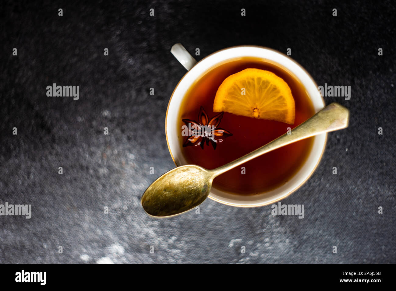 Mulled tea with lemon and spices on stone table with copy space Stock ...