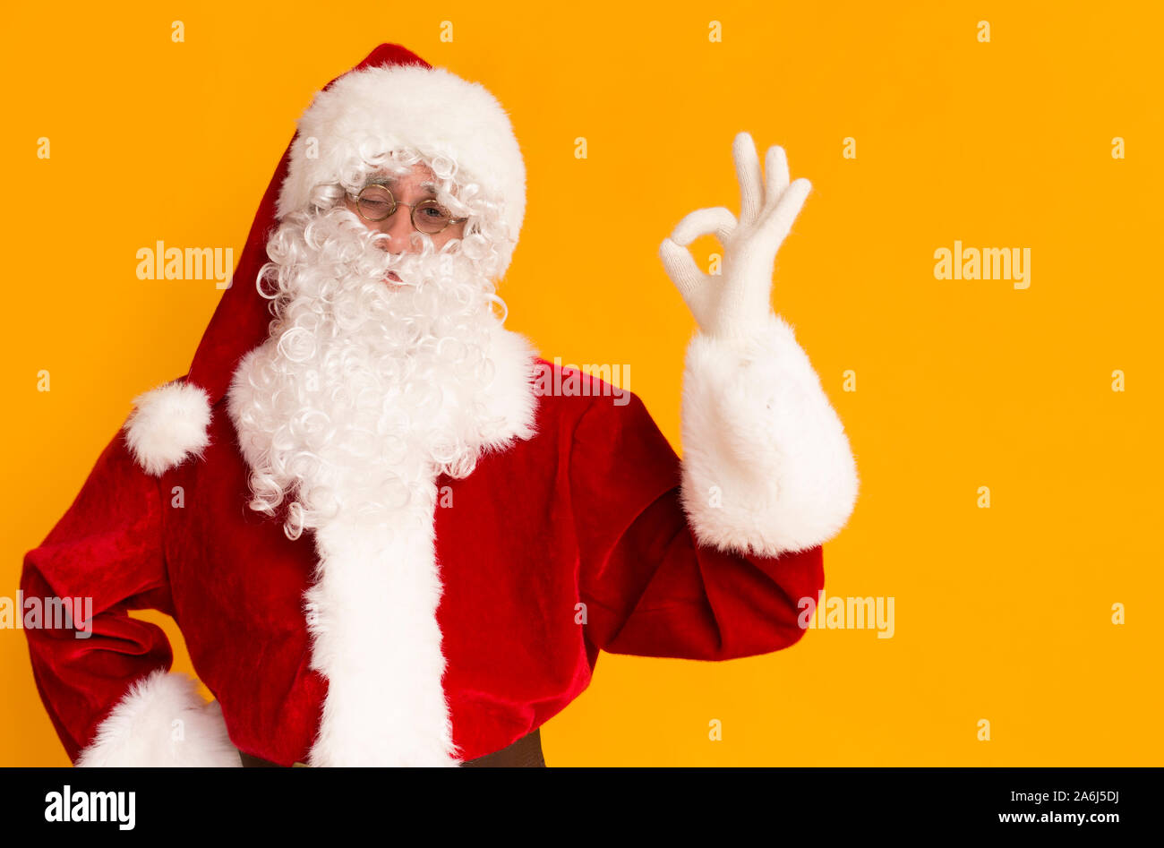 Cheerful Santa Claus with white beard showing ok sign Stock Photo - Alamy