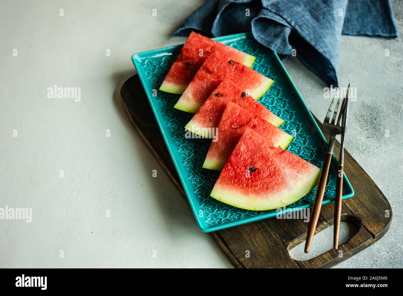 Organic watermelon slice on a plate served on stone background with ...