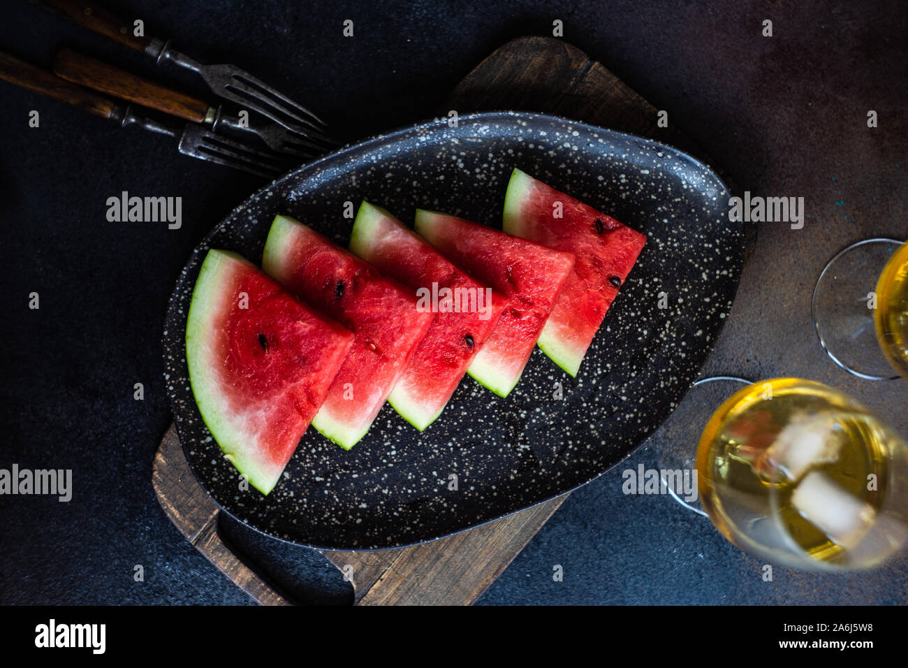 Organic watermelon slice on a plate served on stone background with ...
