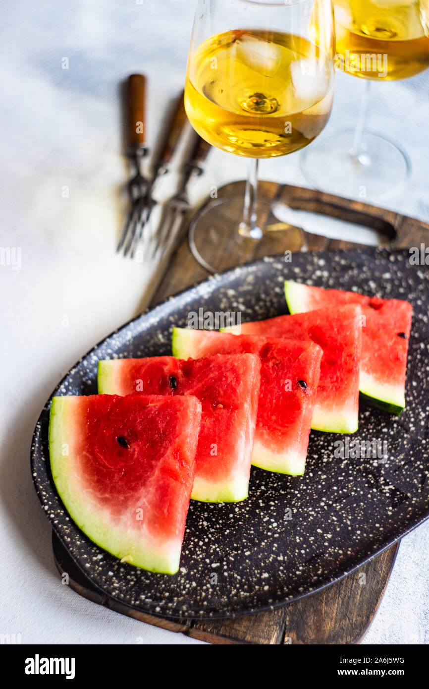 Organic watermelon slice on a plate served on stone background with ...