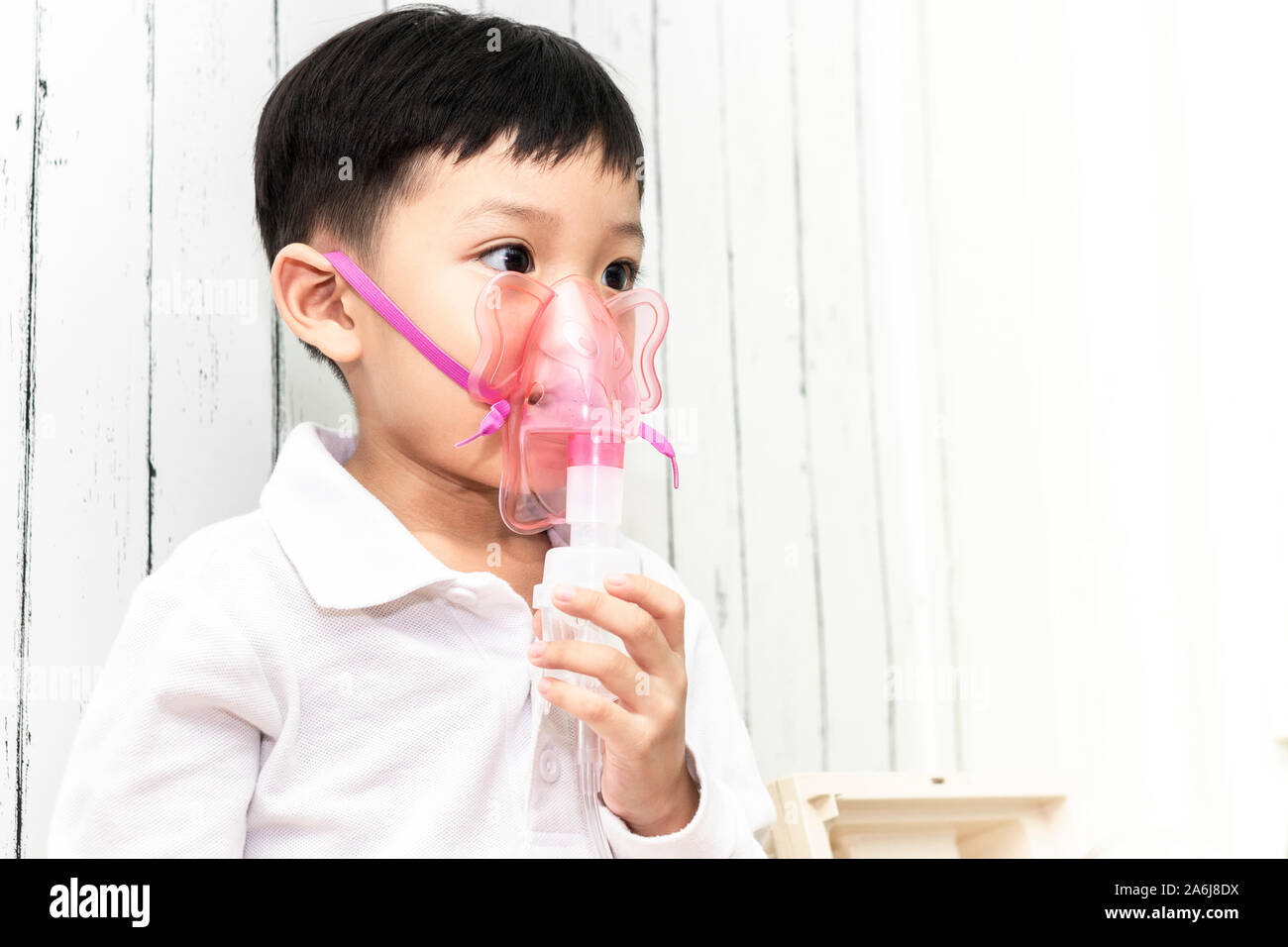 Asia boy using nebulizer and inhaler for the treatment. Little child ...