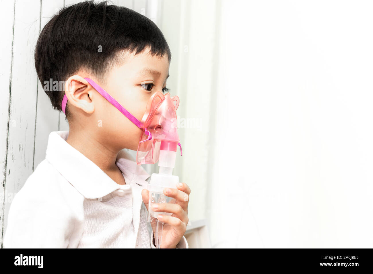 Asia boy using nebulizer and inhaler for the treatment. Little child ...