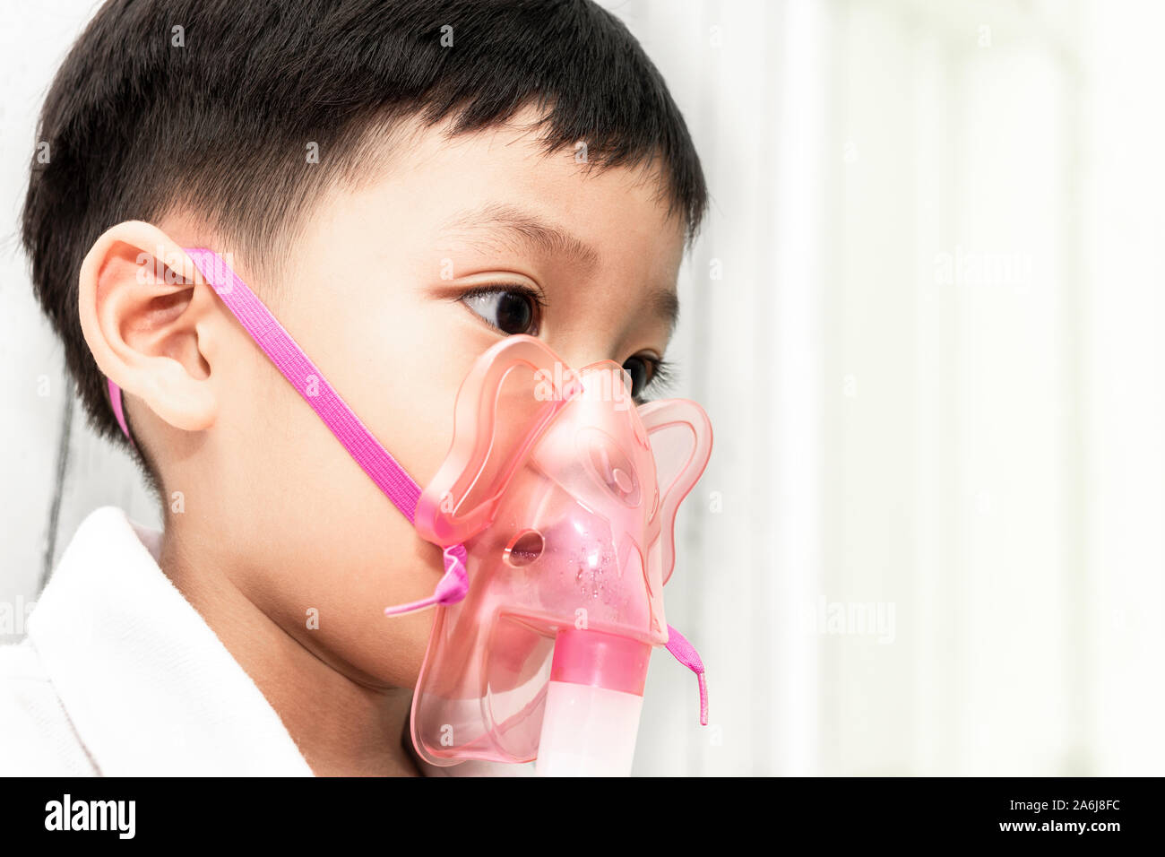 Asia boy using nebulizer and inhaler for the treatment. Little child ...