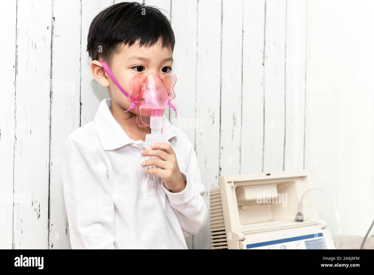 Asia boy using nebulizer and inhaler for the treatment. Little child ...