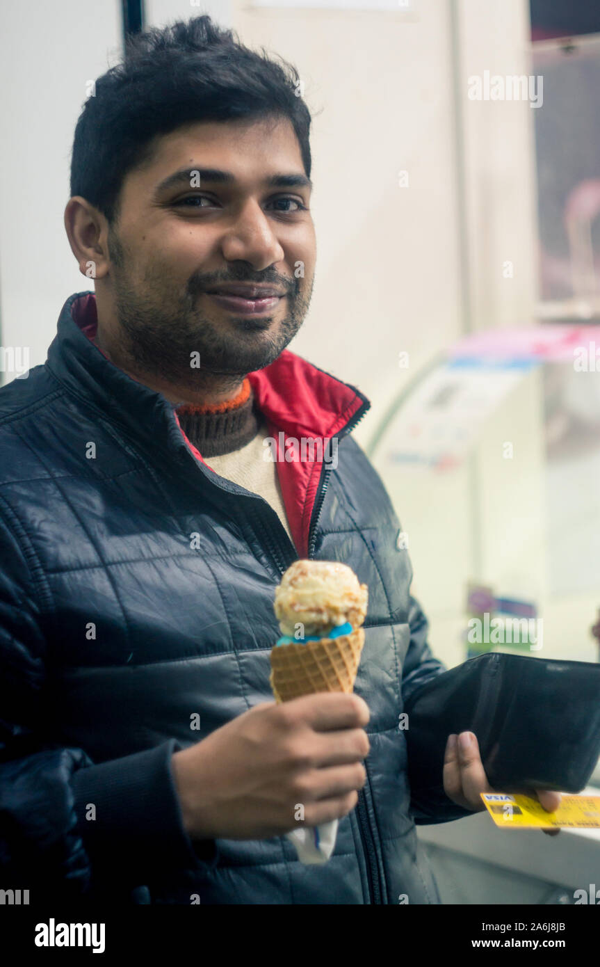 Indian man eating ice cream hi-res stock photography and images - Alamy