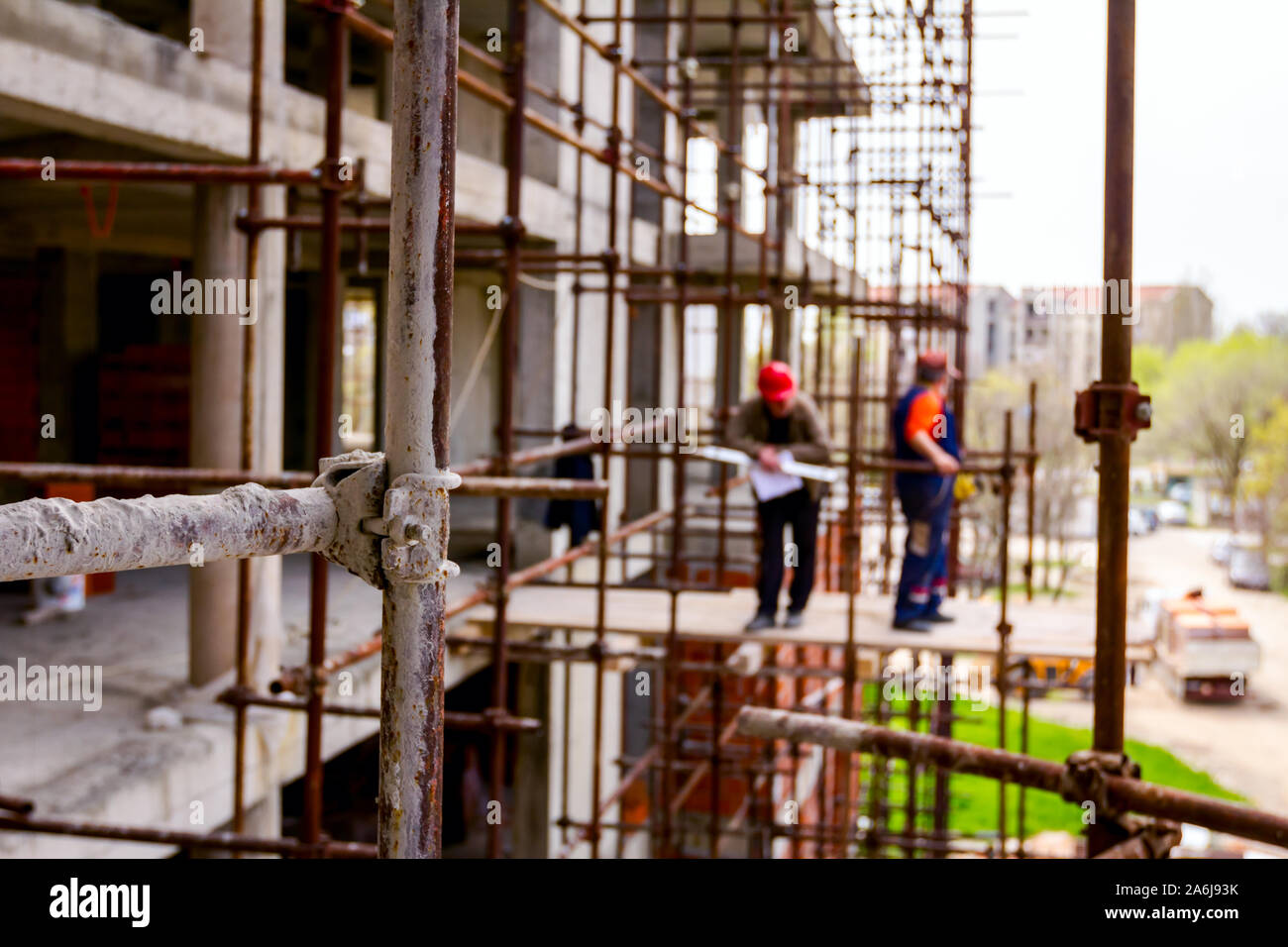 Scaffold is placed against edifice. Boss is oversees from platform ...