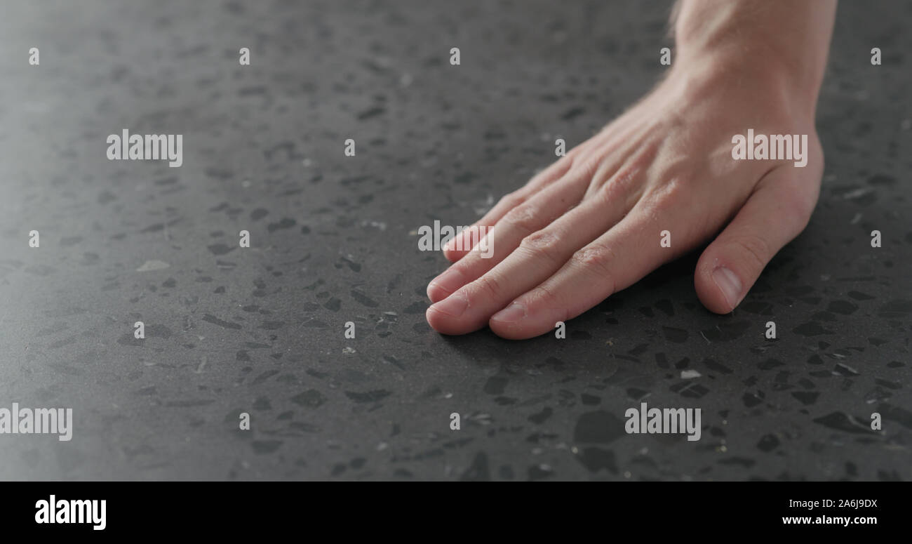 man hand touches terrazzo countertop, wide photo Stock Photo - Alamy