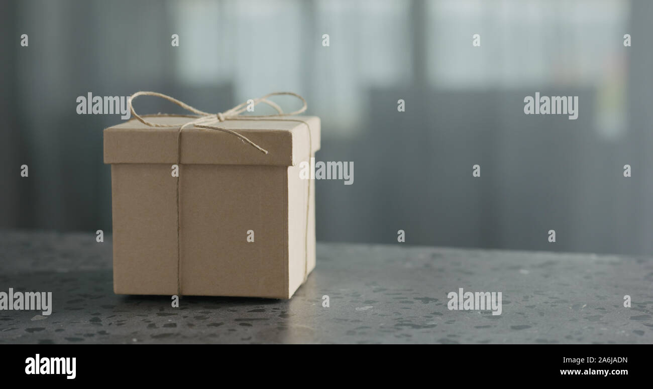 brown paper gift box on terrazzo countertop, wide photo Stock Photo - Alamy