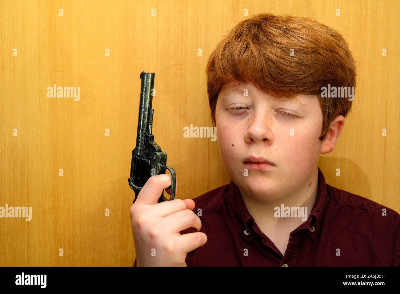 Ginger haired boy with toy gun Stock Photo - Alamy