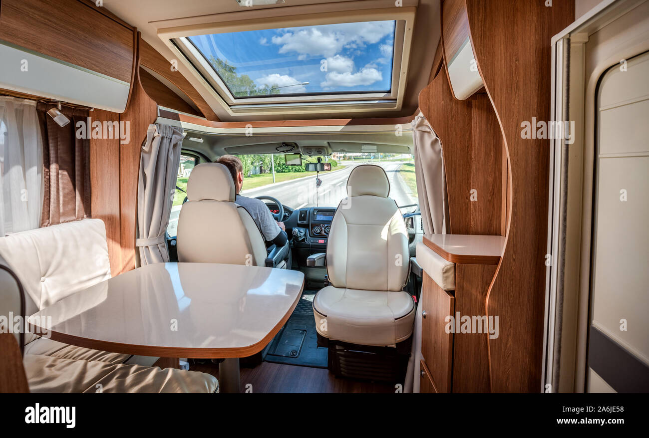 Man driving on a road in the Camper Van RV. Caravan car Vacation ...