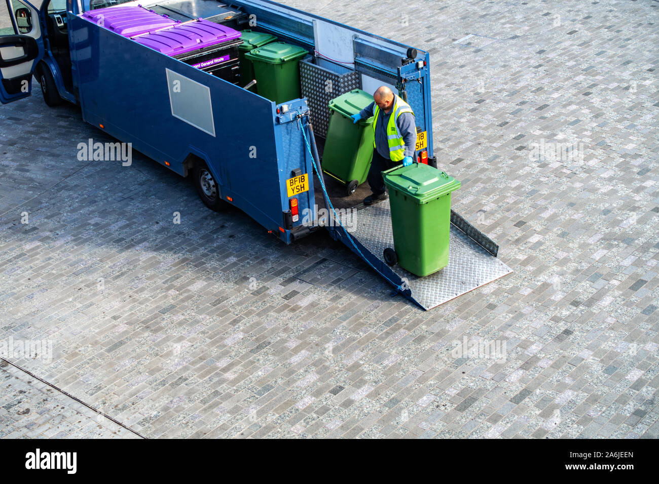 cleaner collecting rubbish bins Stock Photo - Alamy