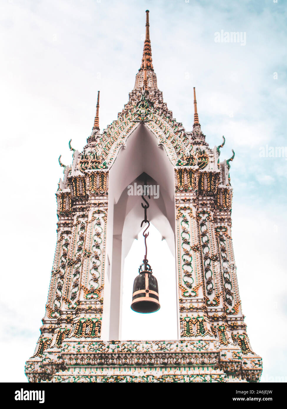 Ring bells in temple. Golden metal bell isolated. Big brass Buddhist ...