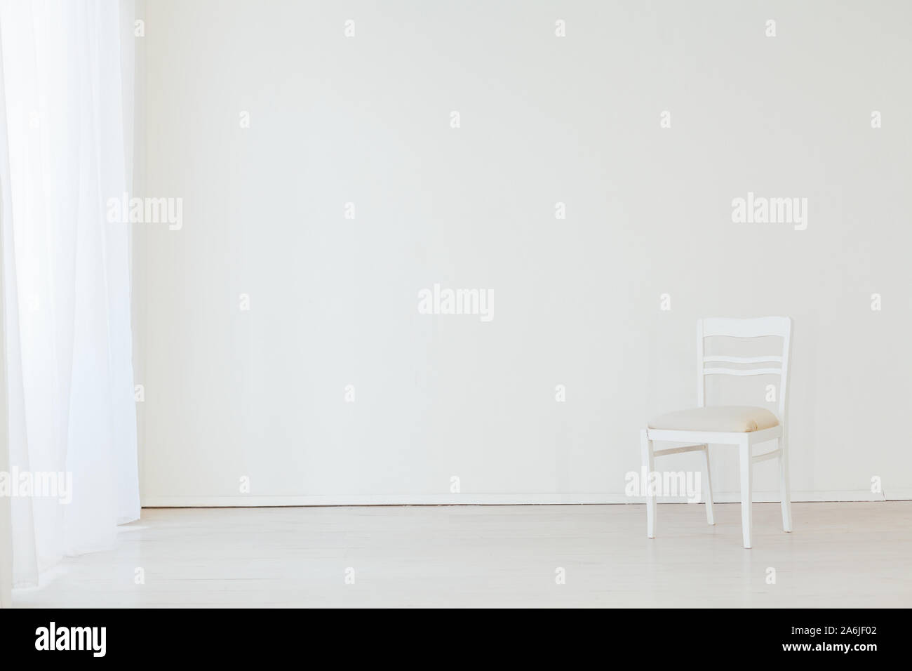 one chair in the interior of an empty white room Stock Photo - Alamy