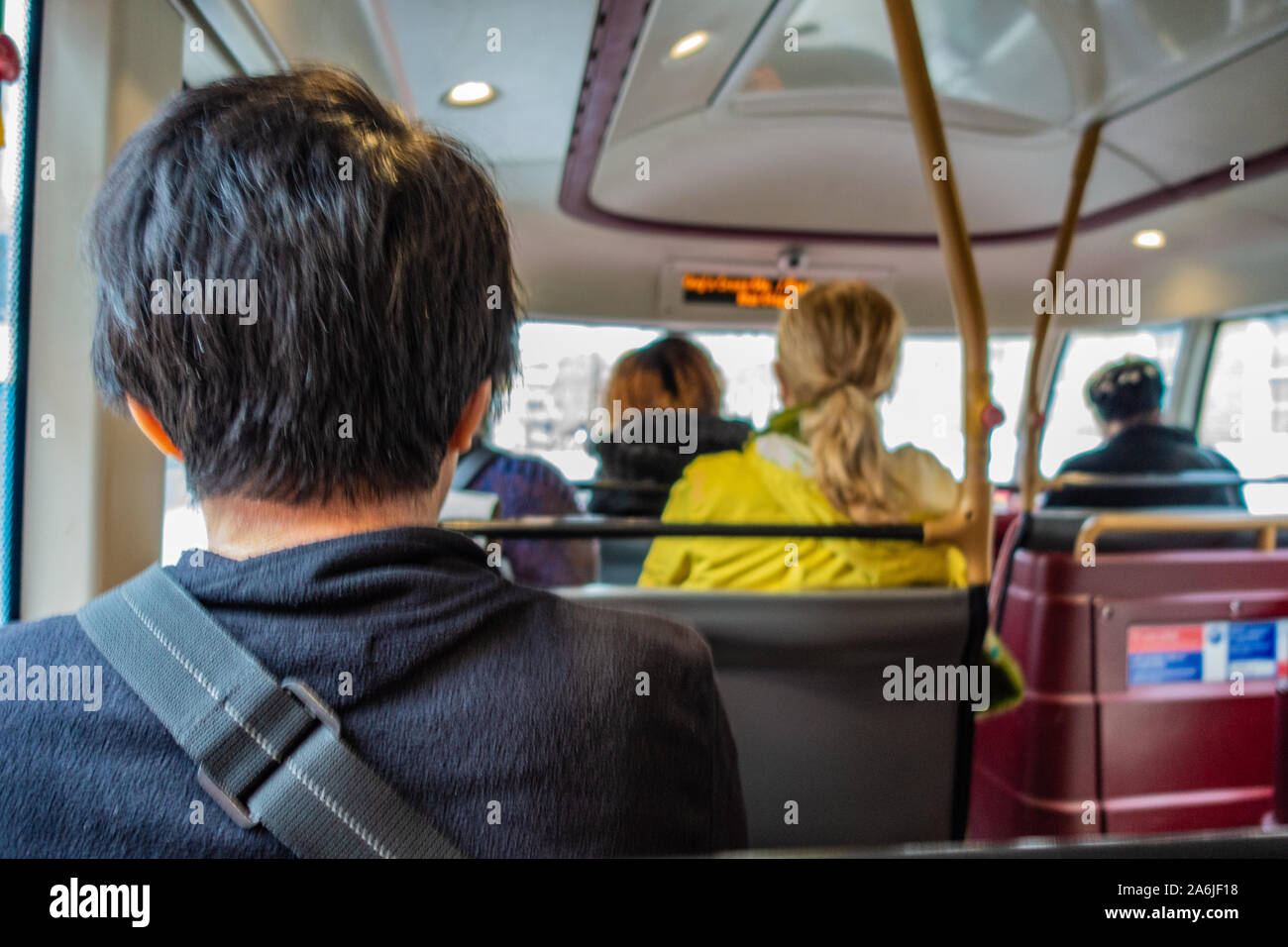 Rear view of person sitting on a bus seat Stock Photo - Alamy