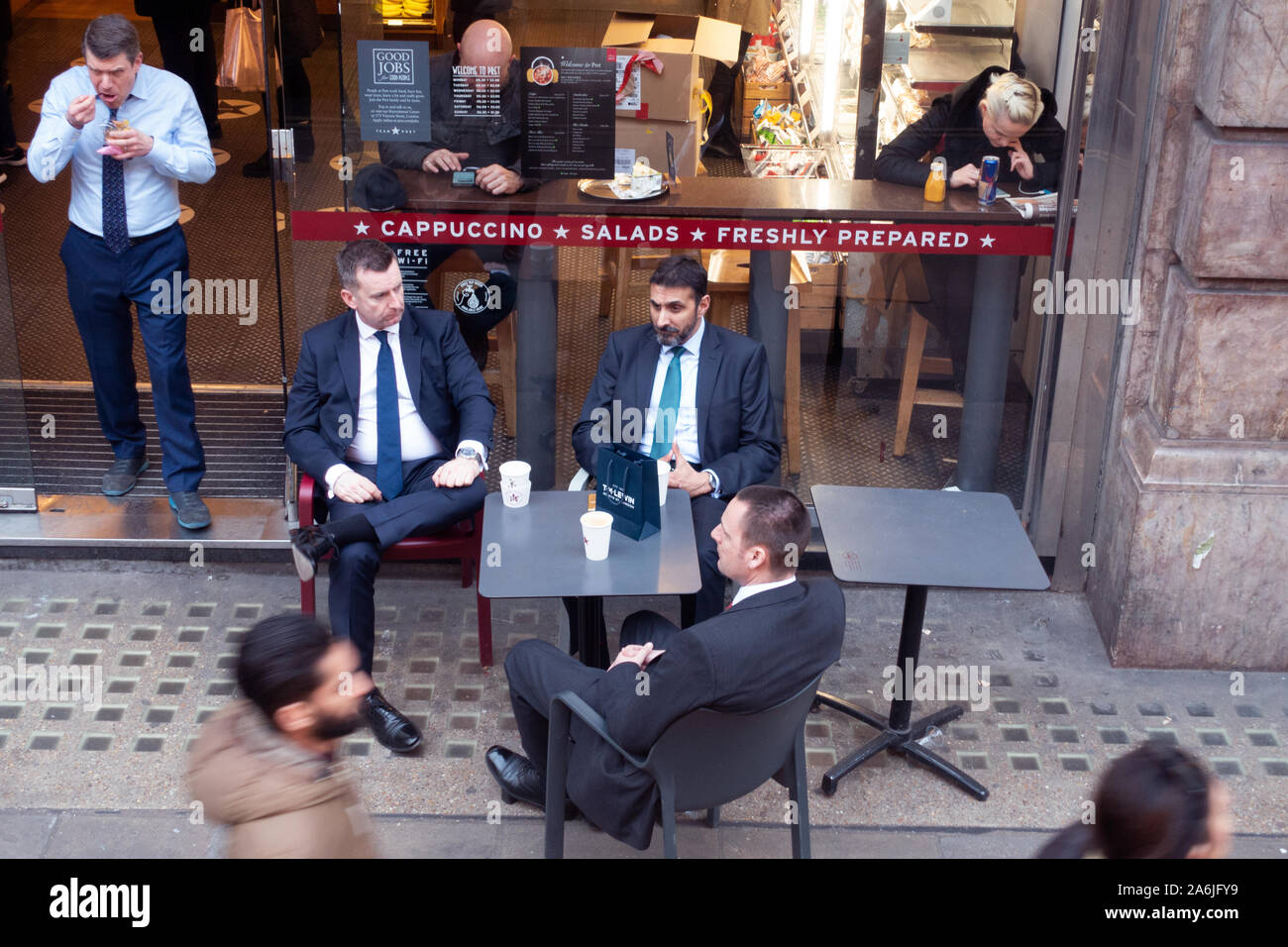Business men chatting sitting outside at coffee shop Stock Photo - Alamy